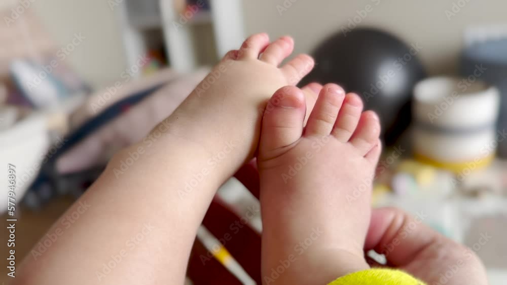 baby feet close-up captured in a cozy room. Kindergarten happy family ...