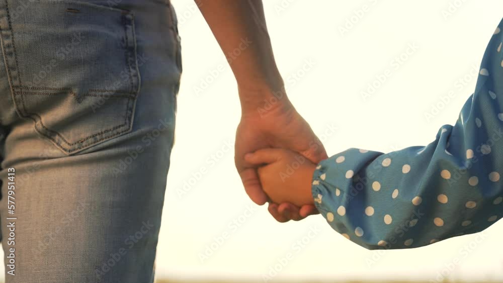 Happy family. Father holds daughter by hand. Family outdoors in park ...