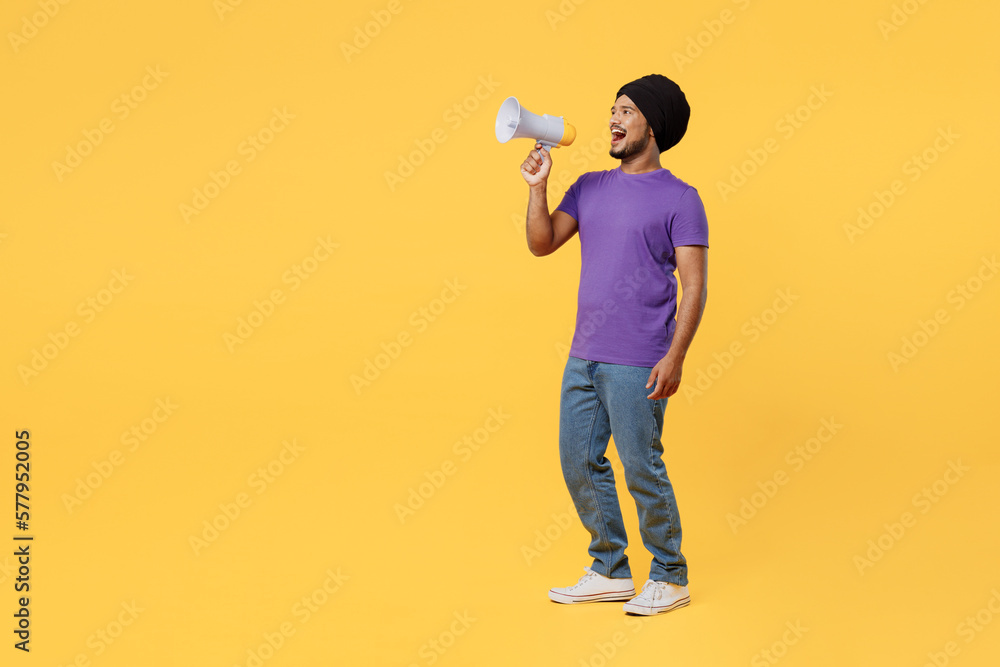 Full body devotee Sikh Indian man ties his traditional turban dastar ...