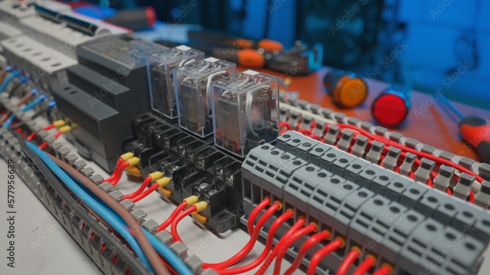 Electrical panel with many red and blue wires, electrical parts ...