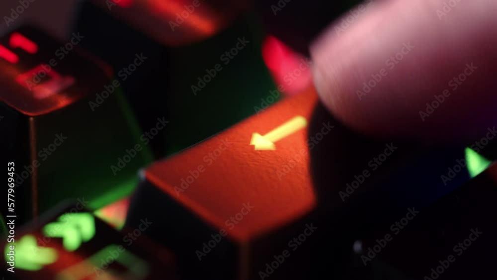 Human finger fast clicks on the backspace button on the computer ...