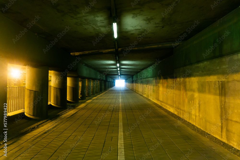 Horror tunnel background. Dark pavement tunnel with bright light at the ...