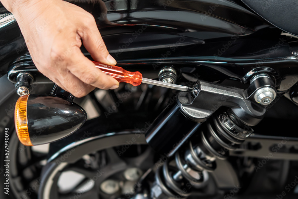 mechanic adjust rear shock to fine tune how soft or firm the ride feels ...