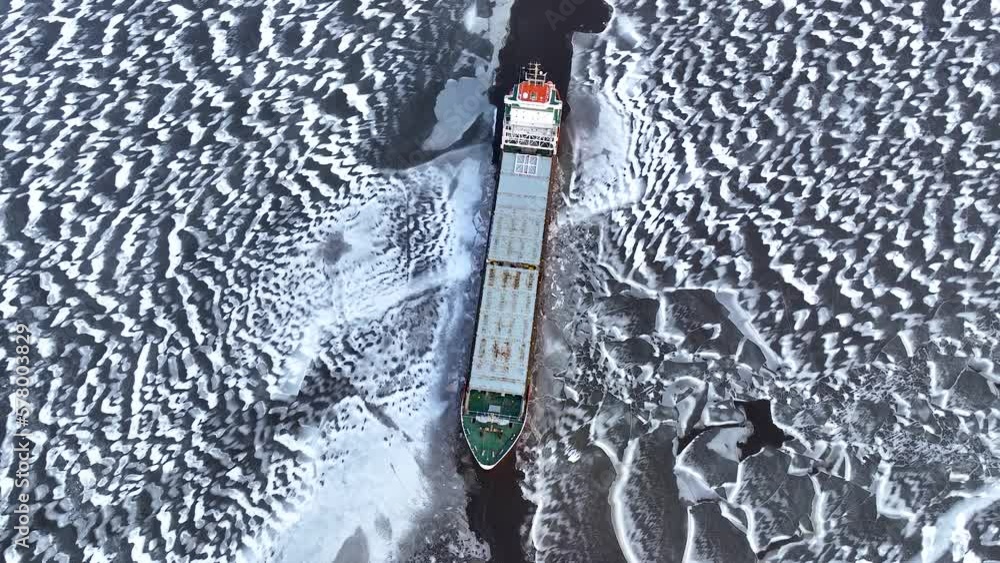 A big red ship frozen in the endless sea of ice. Aerial View of dead ...
