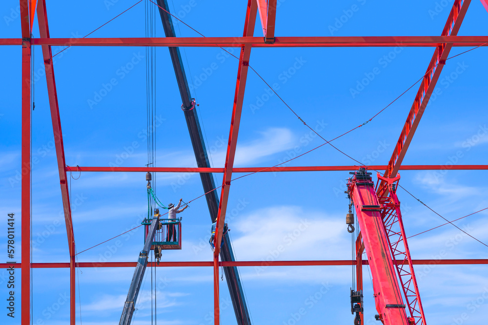 Construction workers with crane truck are installing slings wire ropes ...