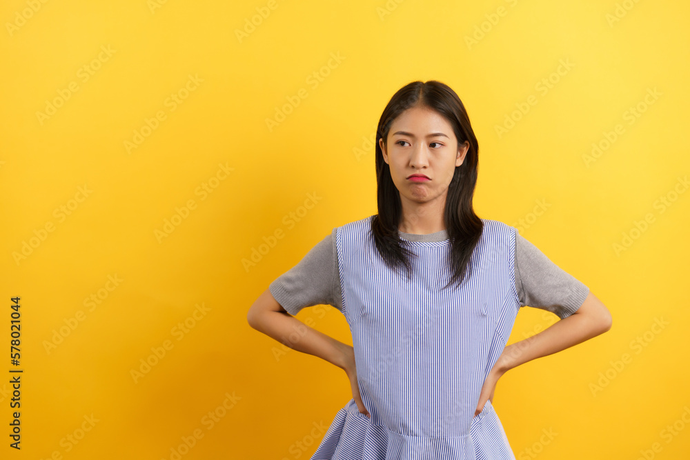 Young women angry face sitting hands on waist akimbo with empty space ...