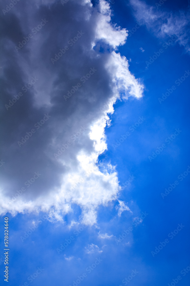Bottom view on clouds. A big grey sky covering the sun. For background ...