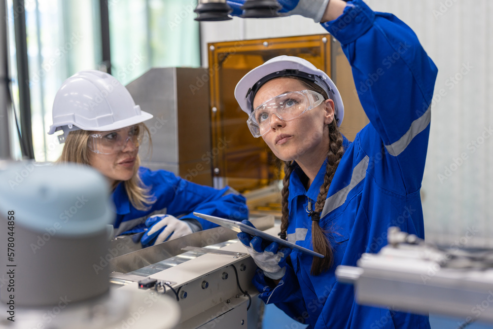 Female automation engineer wear vest with helmet safety checking and ...