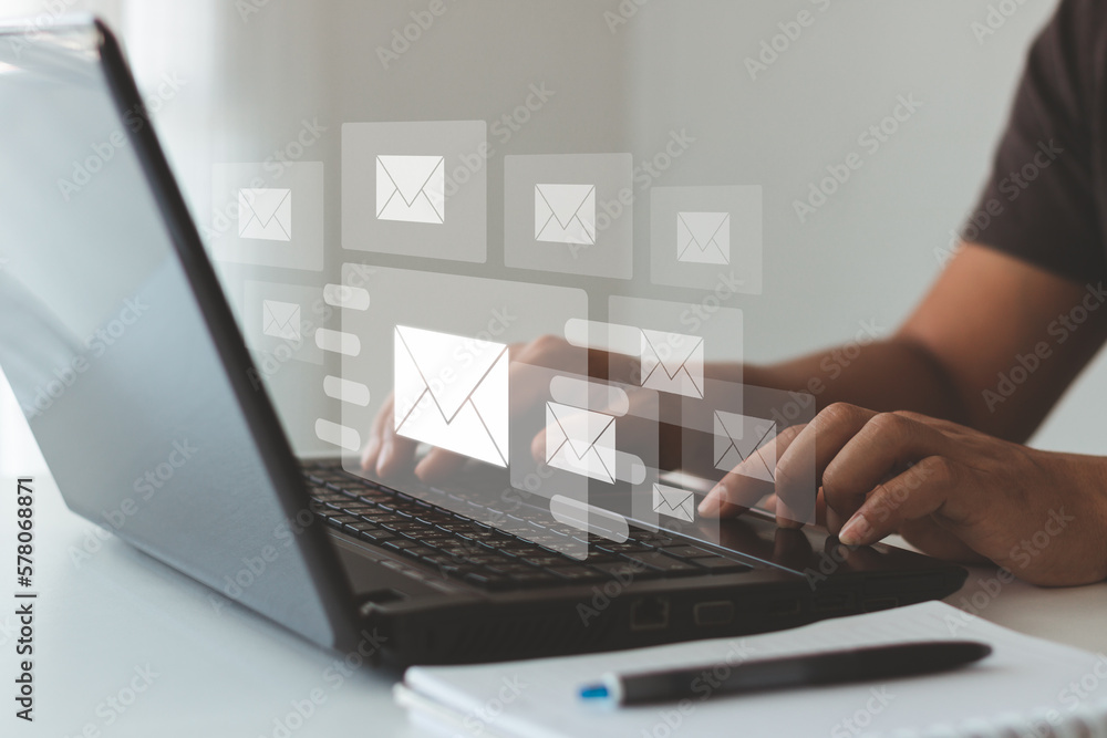 E-mail marketing concept. Business man use a laptop computer with email ...