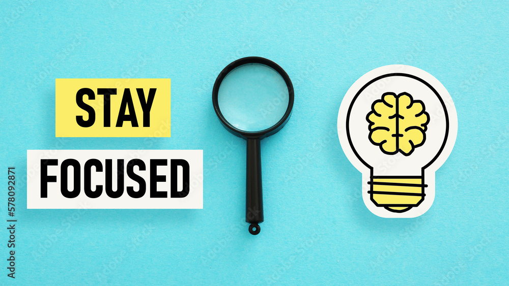 Stay focused is shown using the text and photo of magnifying glass ...