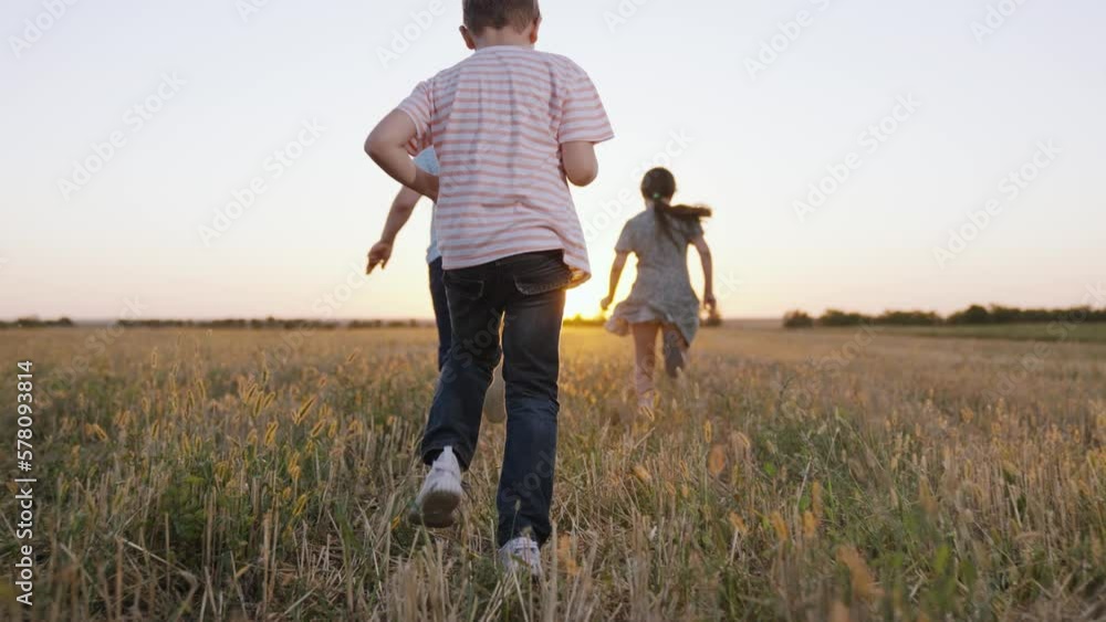 Vídeo do Stock: Children run on grass, sunset. Child plays outdoors ...