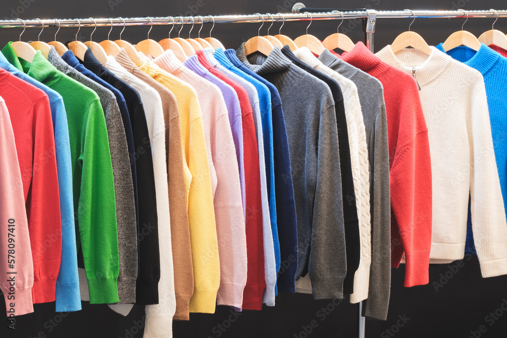 Fashion clothes on clothing rack Closeup of rainbow color choice female ...