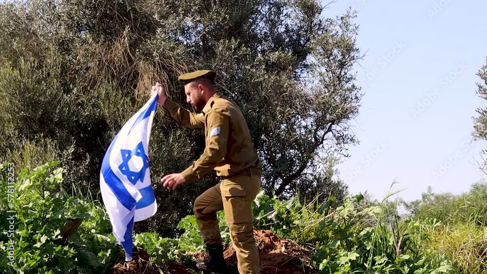 Israeli Soldier, climbing to the top of a mountain, kisses the Flag of ...