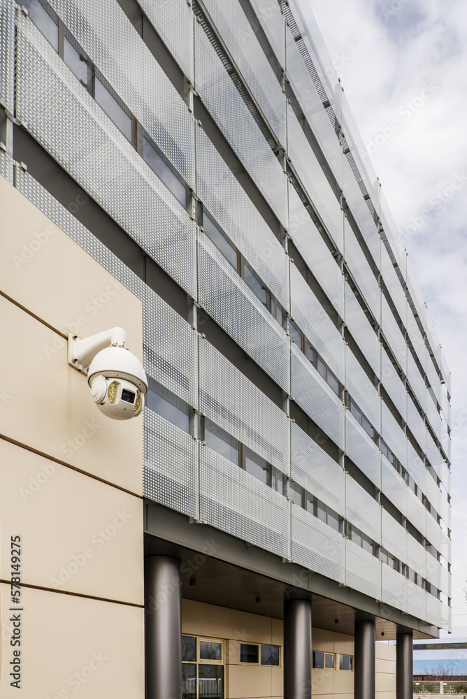 office building facades with large windows, a porch on the ground floor ...