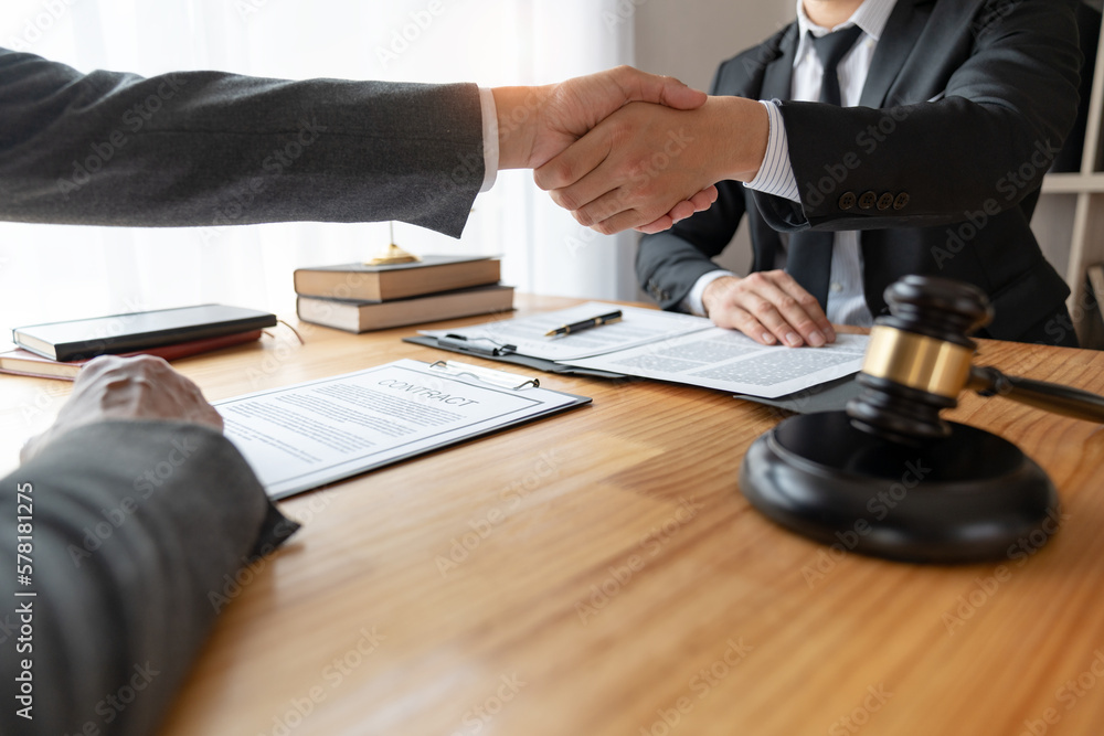 Lawyers shake hands with business people to seal a deal with partner ...
