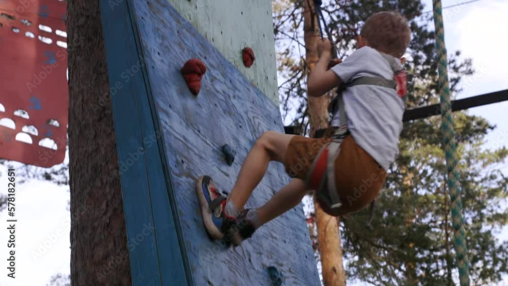 Video Stock Brave boy independently climbed to top of climbing wall and ...