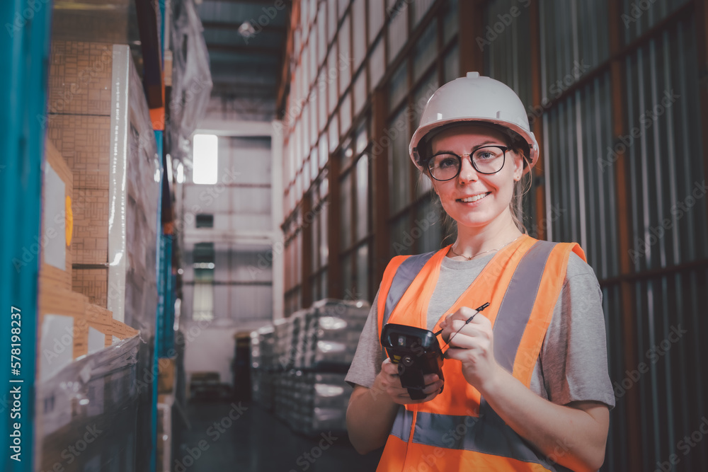Female workers in safety helmet using scanner checking inventory stock ...