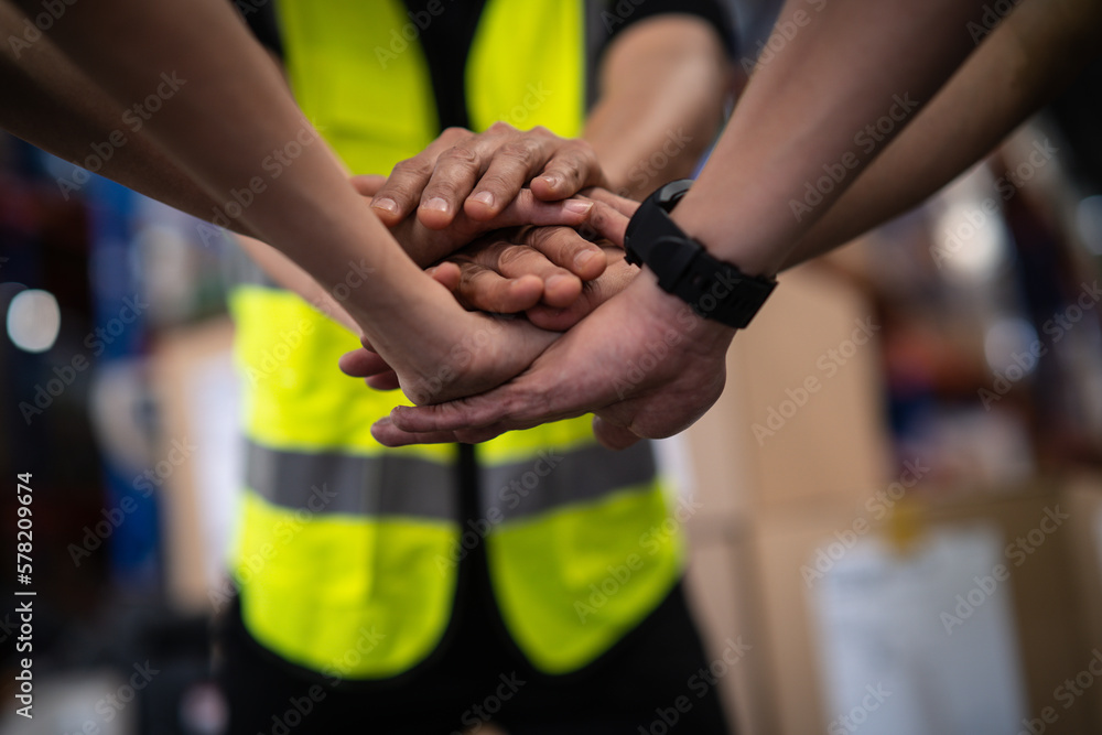 Close up view of warehouse workers putting their hands together. Stack ...
