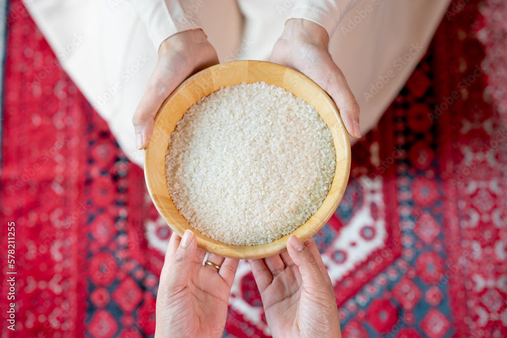 Hands Holding A Wooden Bowl Of Rice Grains For Zakat Islamic Zakat