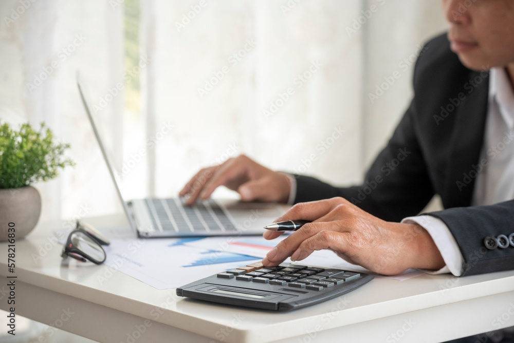 Asian businessman hands calculating number, graph, chart audit planning ...