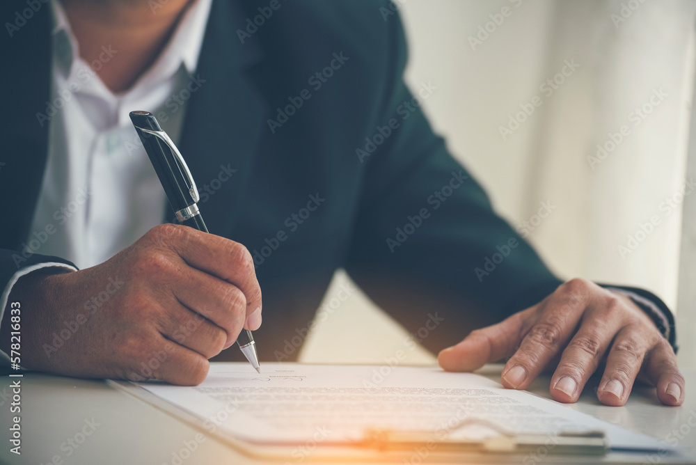 Businessman hand using pen signing on new contract to starting projects ...
