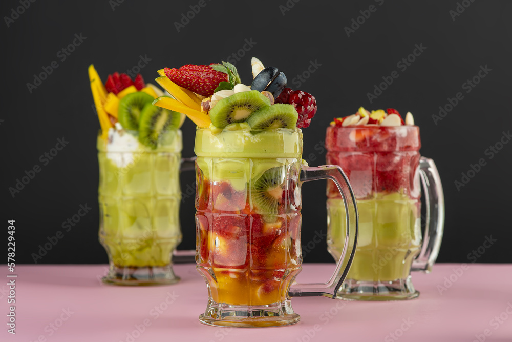 set of Fruit cocktails with fruit topping, Avocado, strawberry, Mango ...