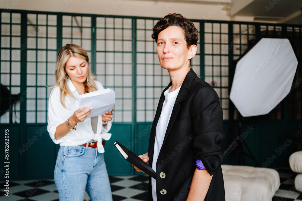 Confident movie director standing with actress on film set Stock Photo ...