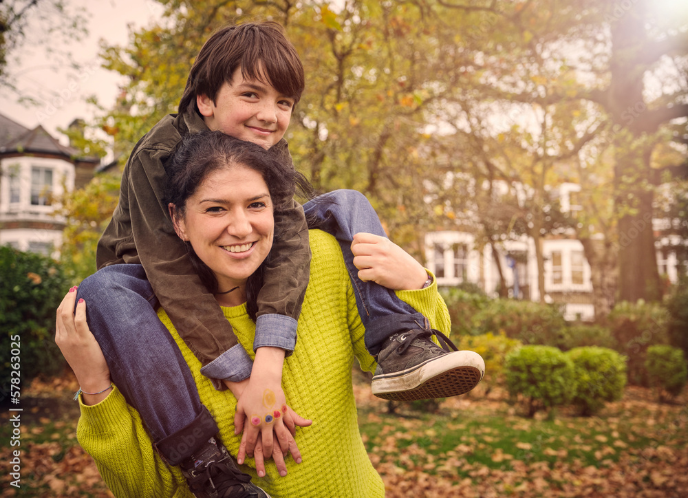 Happy aunt carrying nephew on shoulders at park Stock Photo | Adobe Stock