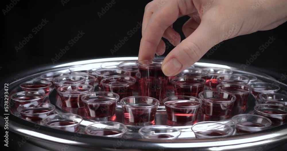 Closeup of young woman taking communion the wine symbol of Jesus Christ ...