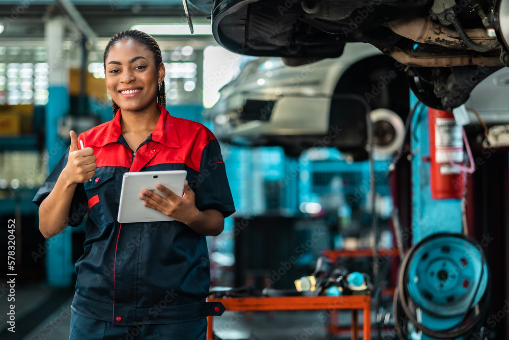Engineer team checking under car condition on lifter in garage.Young ...