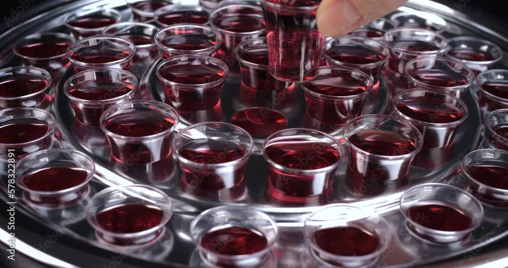 Closeup of young woman taking communion the wine symbol of Jesus Christ ...