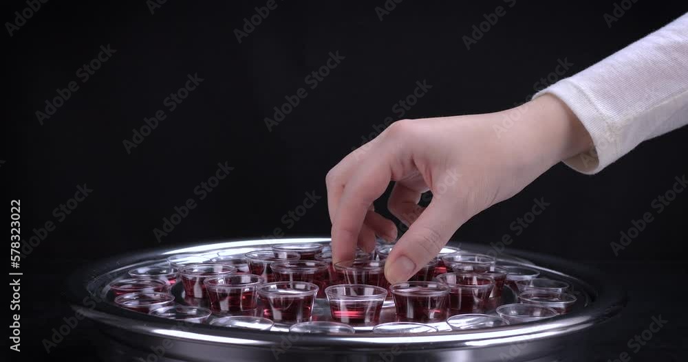 Closeup of young woman taking communion the wine symbol of Jesus Christ ...