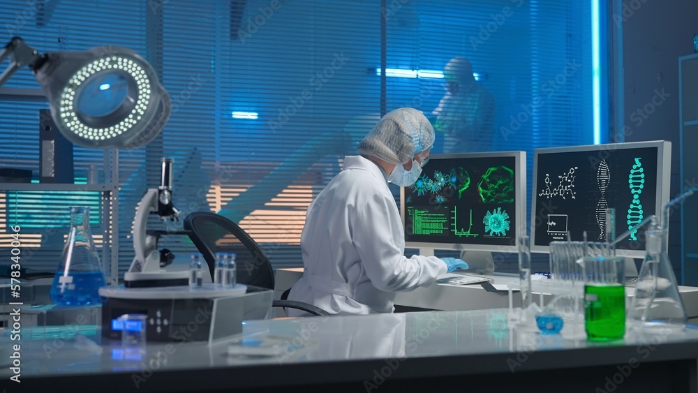 Foto de Medical development laboratory. A female scientist types on a ...