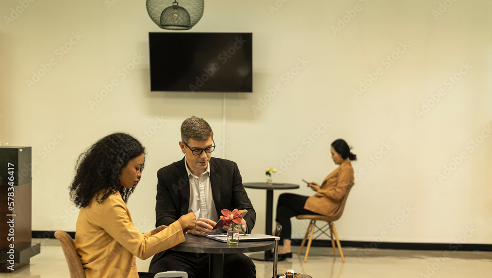 Two business workers are waiting and taking facility service at an ...