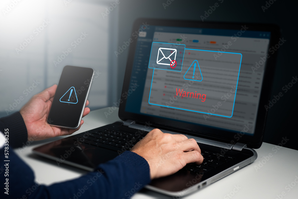 A businessman sees a caution window while working on a laptop at home ...