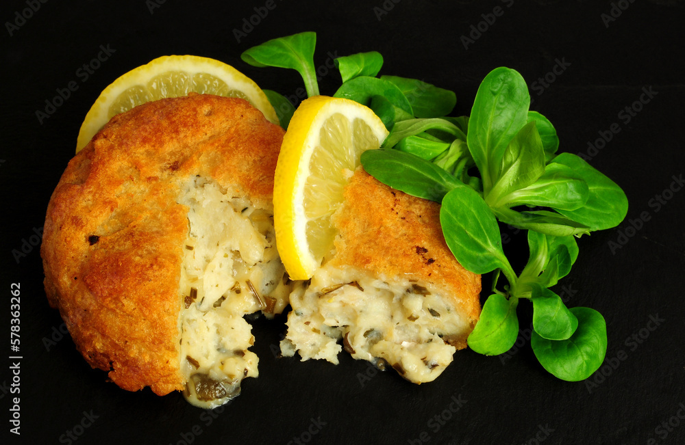 Battered haddock and potato fish cakes with lemon and lambs leaf ...