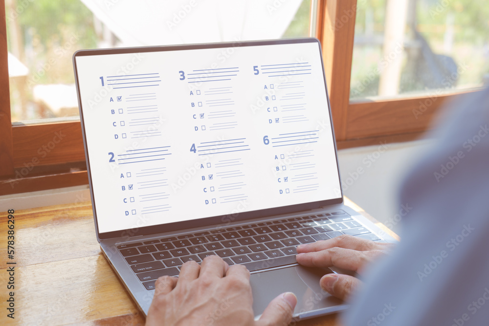Questionnaire online with checkboxes. A man passing online exam ...