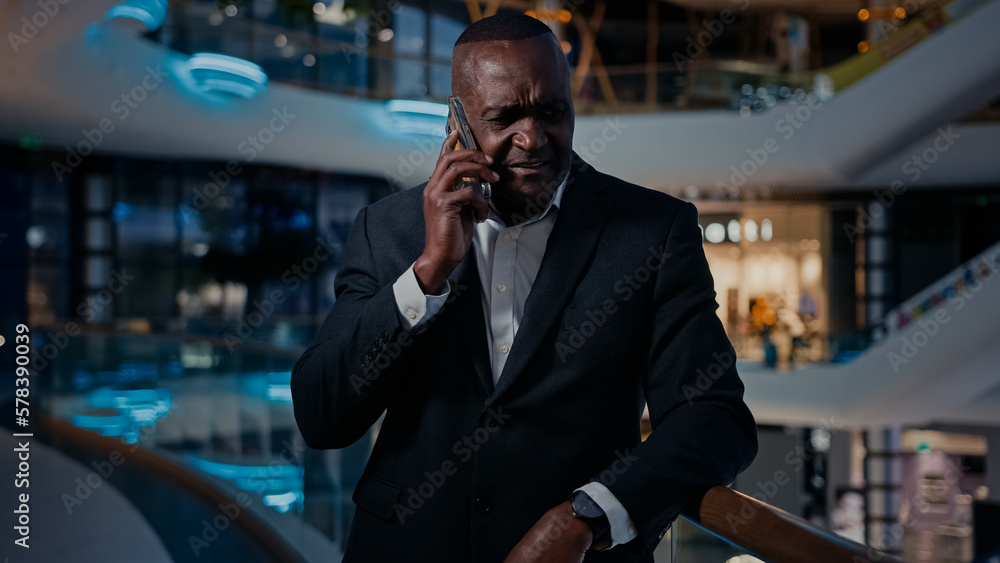 Sad ethnic middle-aged man African American entrepreneur answer phone ...