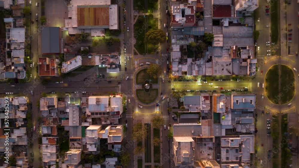 Ascending zenithal shot of the city. The city lights are turning on in ...