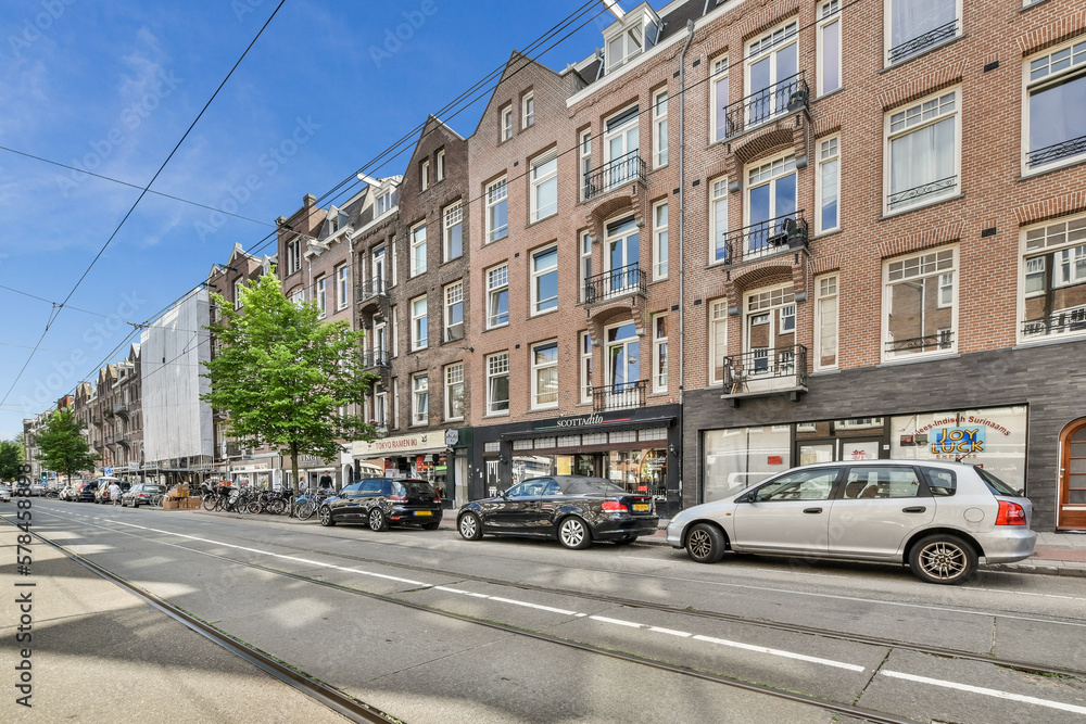 Amsterdam, Netherlands - 10 April, 2021: a city street with cars parked ...