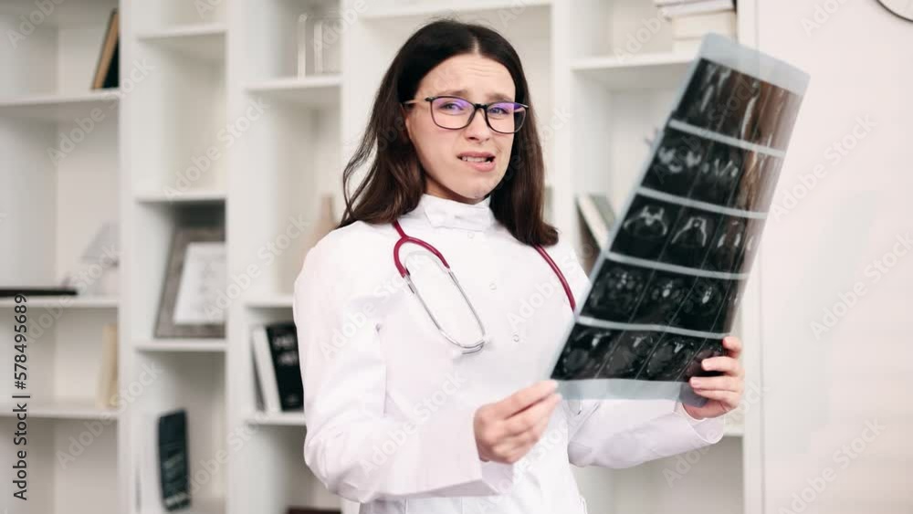 Portrait of doubtful young woman doctor therapist with glasses looking ...
