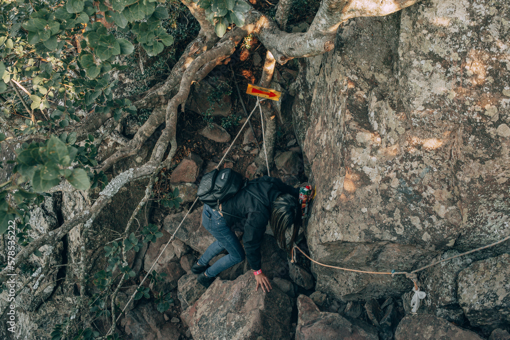 Mujer subiendo un risco en cerro de paraguay Stock Photo | Adobe Stock