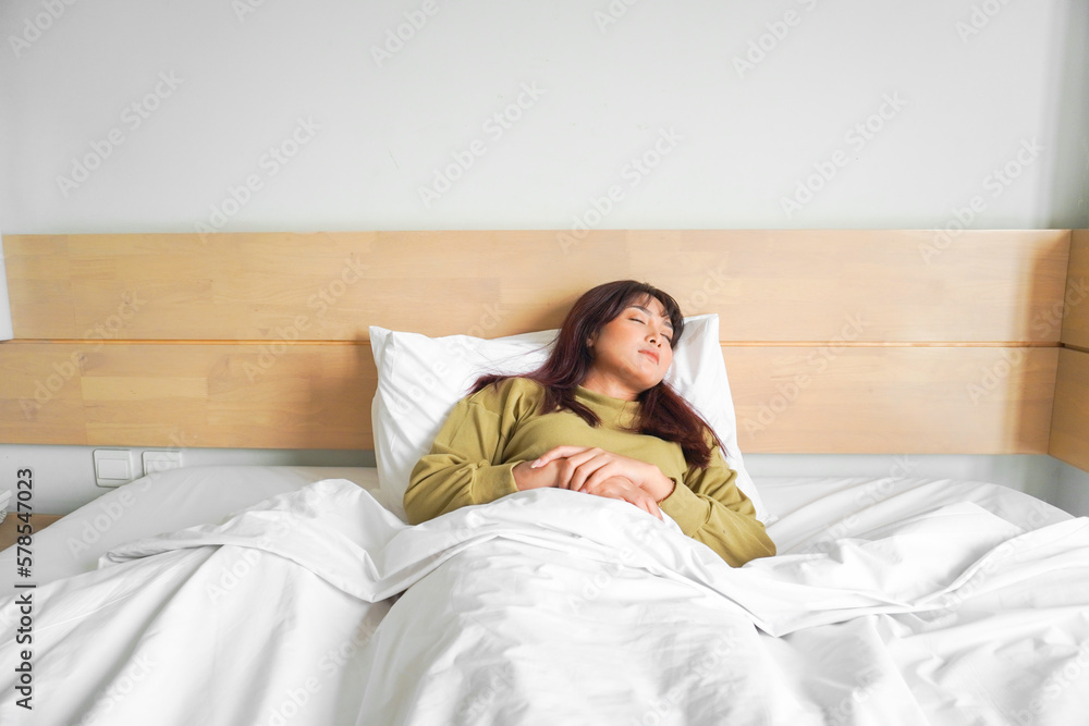 Young beautiful Asian woman sleeping in her bed and relaxing in the ...
