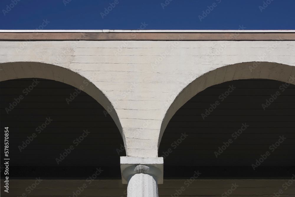Arches and a column along a walkway in Spanish style building Stock ...