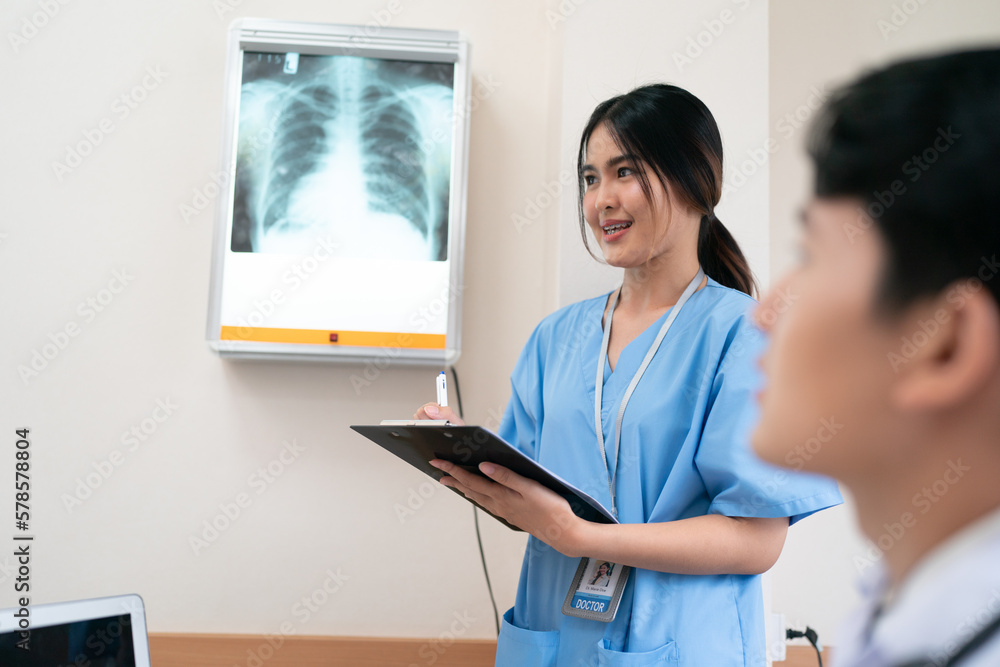 Young and successful Asian young female doctor in uniform wearing ...