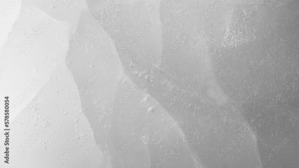 Macro crushed ice texture with splashing water surface, water drops and ...
