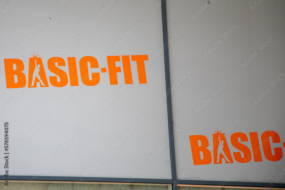 Basic-Fit fitness club brand sign text and logo entrance wall of sporty ...