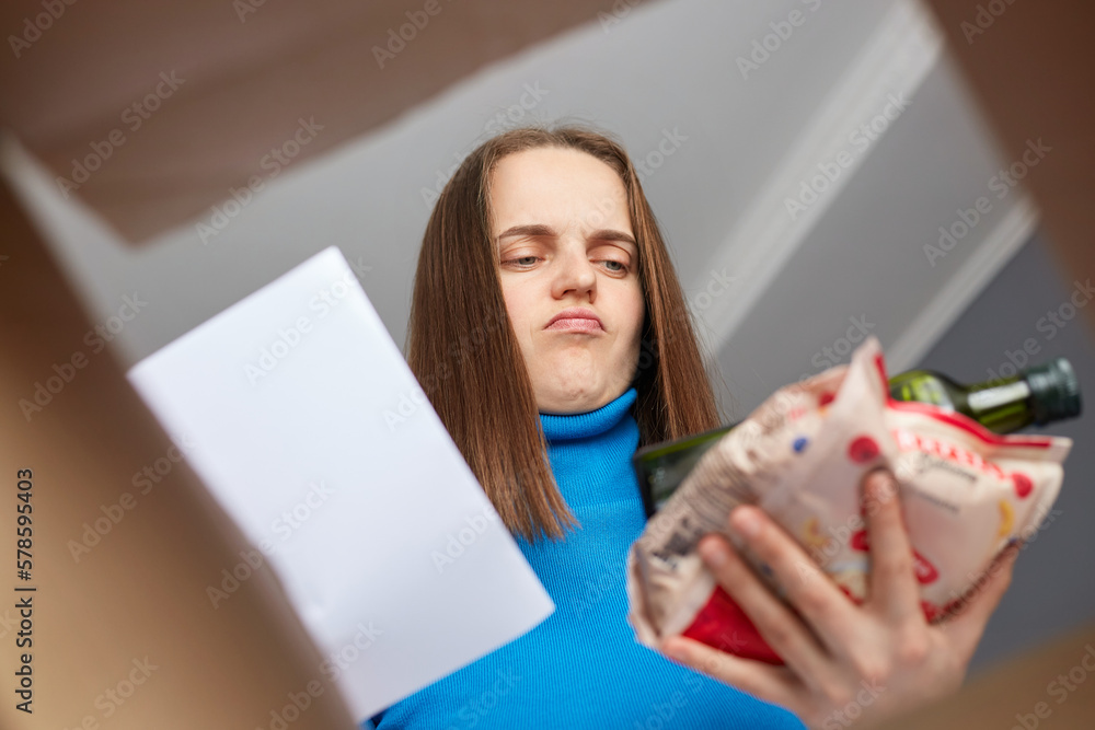 Disappointed irritated sad woman customer receive wrong order of ...