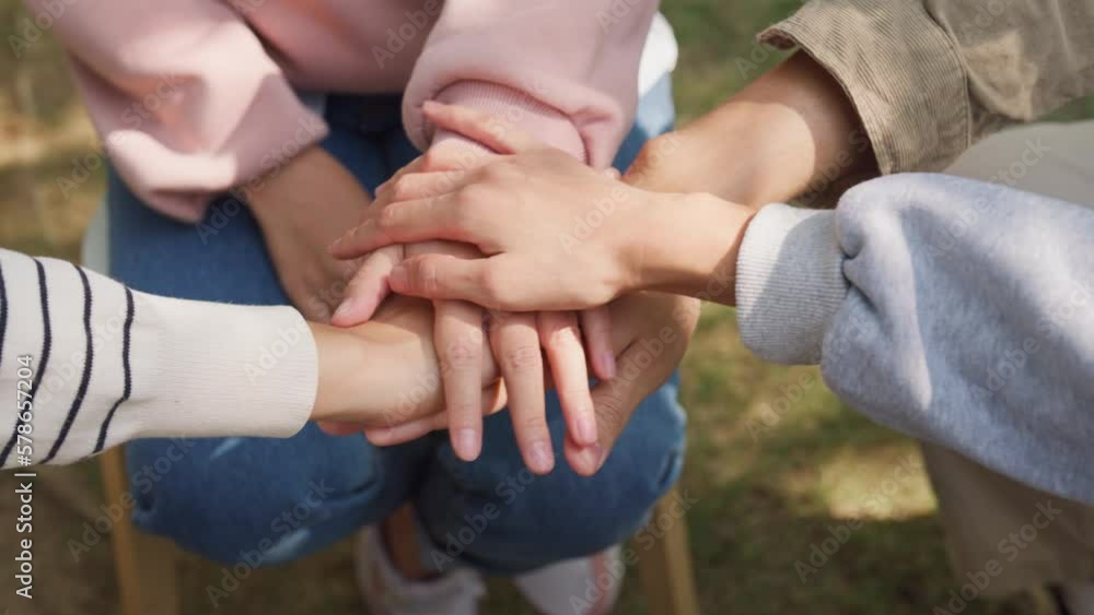 Close-up of diverse multiracial men and women group sit in circle hold ...