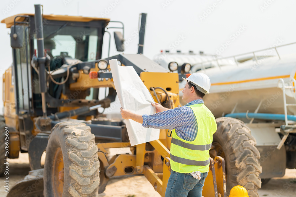 Handsome engineer man and architect working at construction site with ...